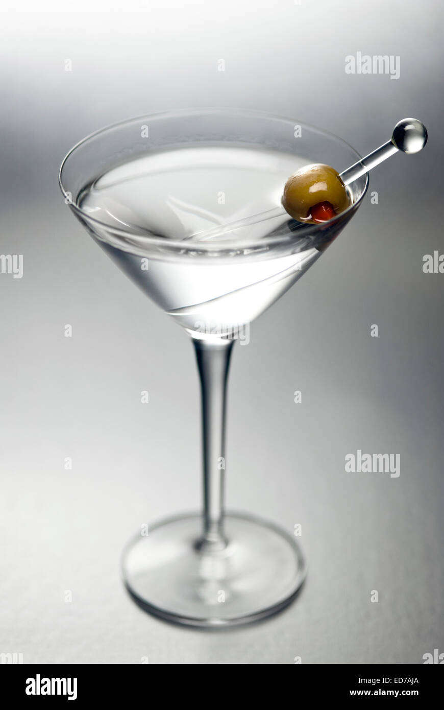 A contrasty modernistic martini cocktail alcoholic beverage with olive ...