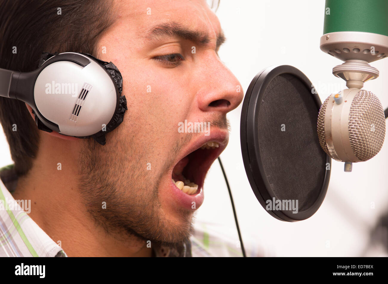 handsome man singing in music studio Stock Photo - Alamy