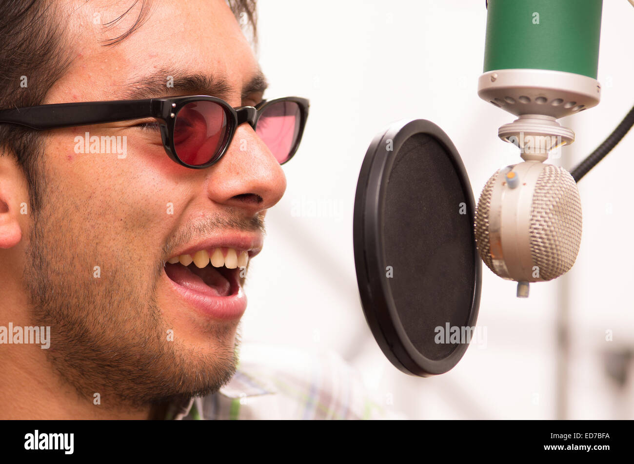 handsome man singing in music studio Stock Photo - Alamy