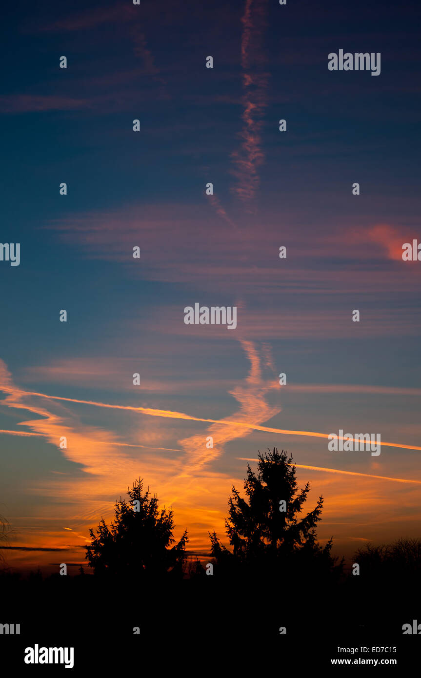 Evening aeroplane contrails sunset light Stock Photo - Alamy