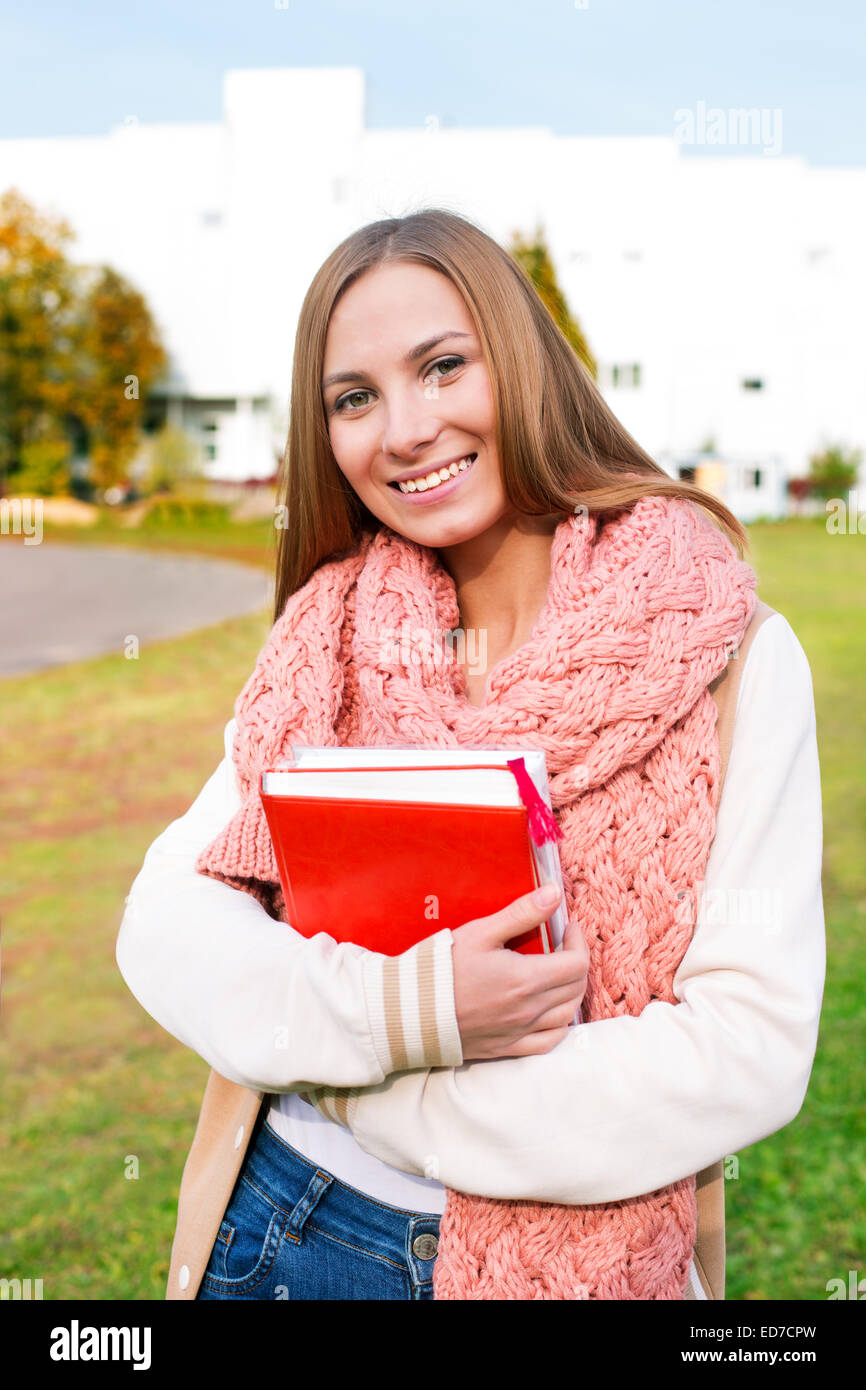 Student wearing scarf and standing on building background Stock Photo ...