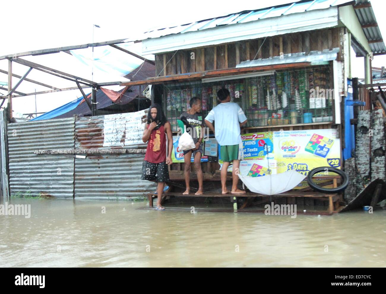 Mindanao, Philippines. 30th December, 2014. People walk through the ...
