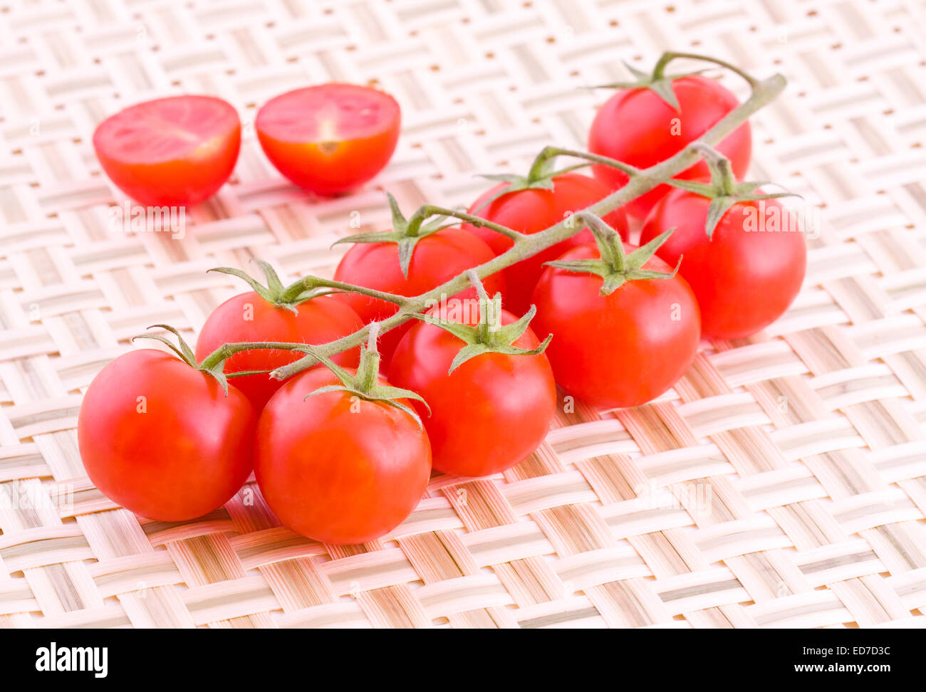 Bunch of fresh small cocktail tomatoes on a straw braided mat Stock ...