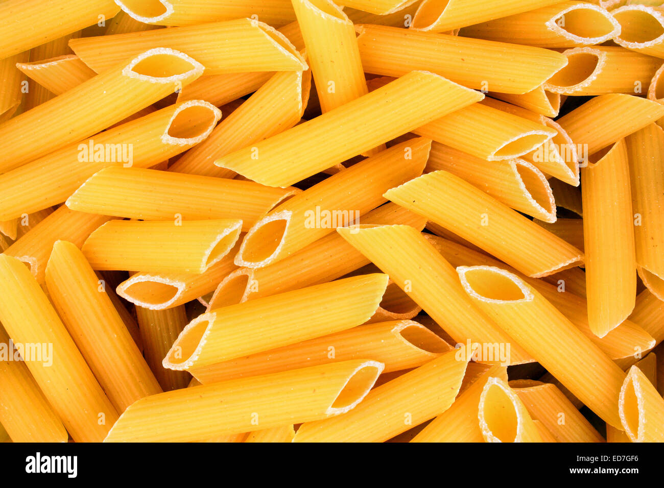 Italian penne rigate macaroni pasta raw food background Stock Photo - Alamy