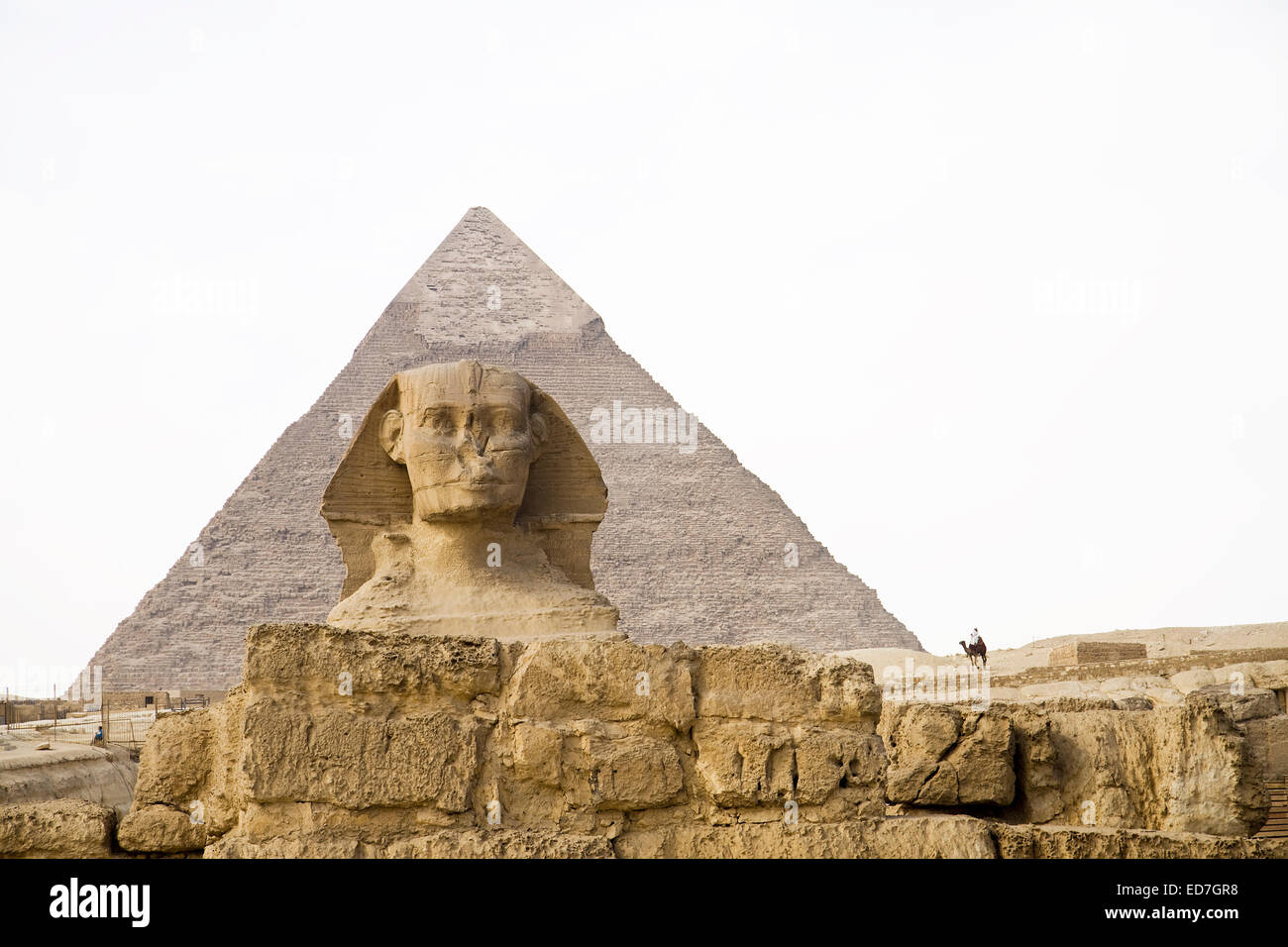 Ancient Egyptian Sphinx with old historic pyramid behind Stock Photo ...