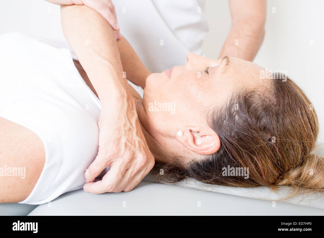 Doctor applying neck manipulation on a aged woman Stock Photo - Alamy