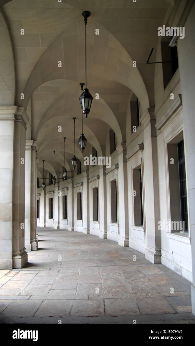 A bright stone passageway with a row of windows on the right Stock ...