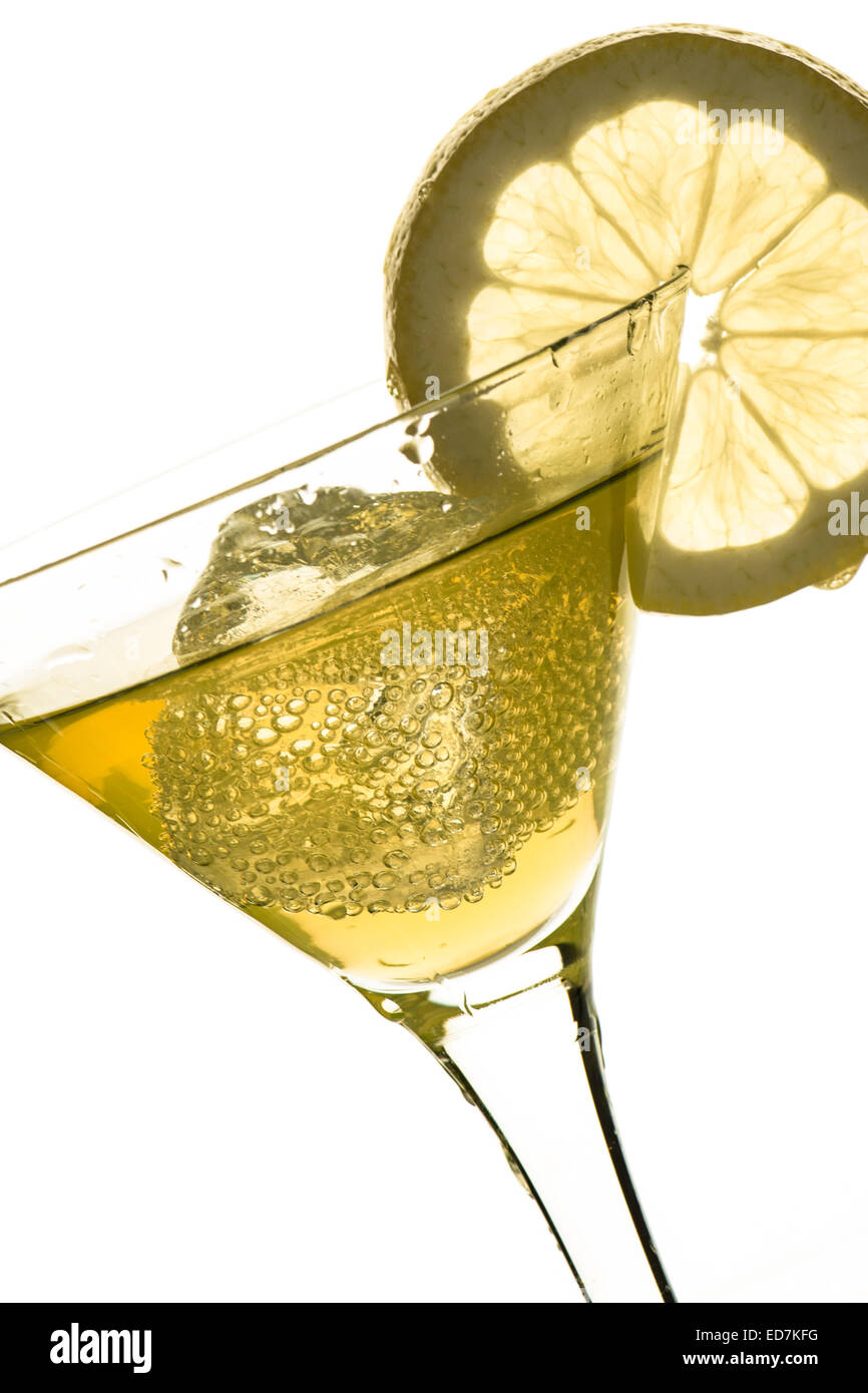 Glass with drink, ice cube and yellow lemon Stock Photo - Alamy