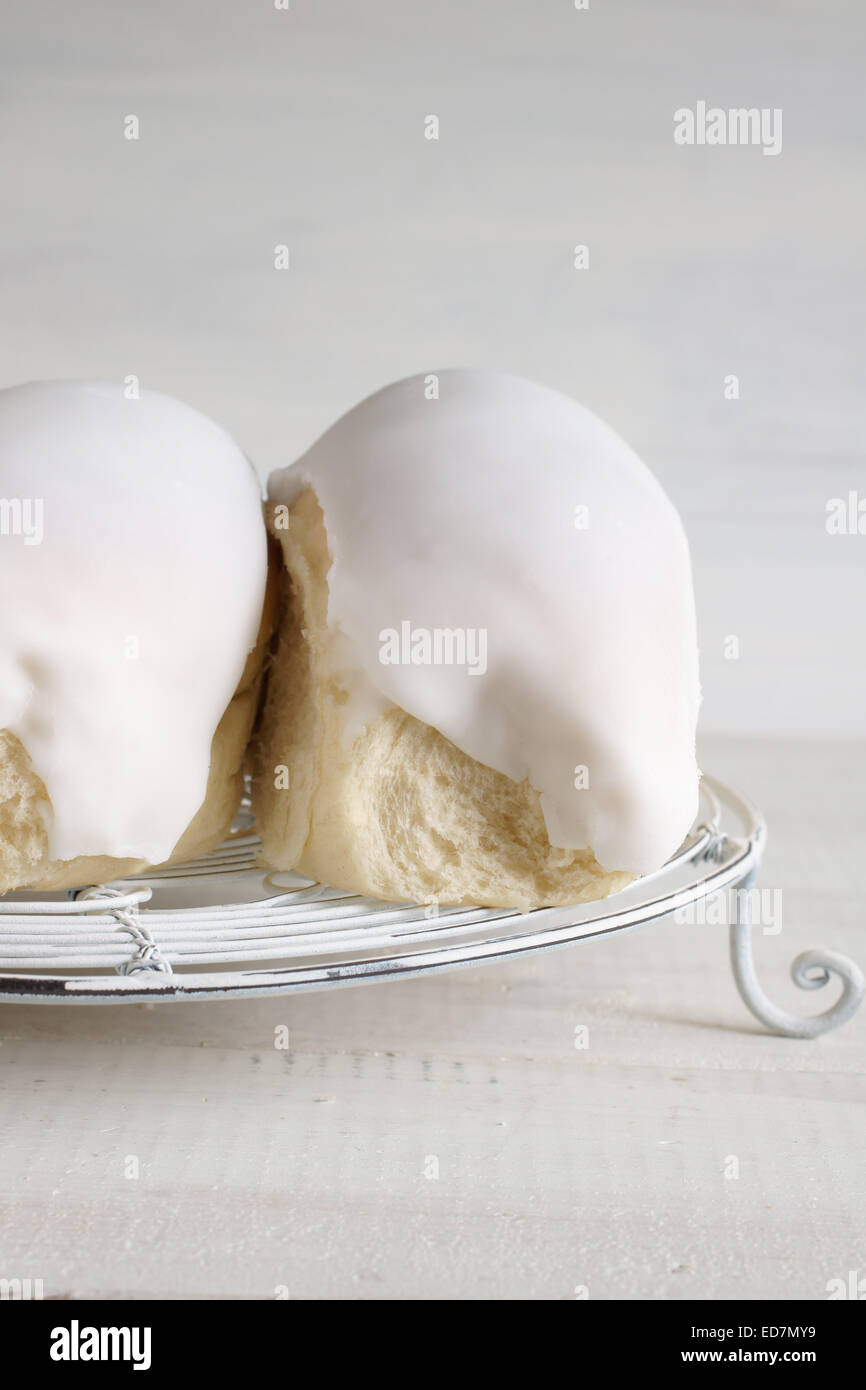 Iced buns or fingers a cake made from a bread roll covered with icing ...