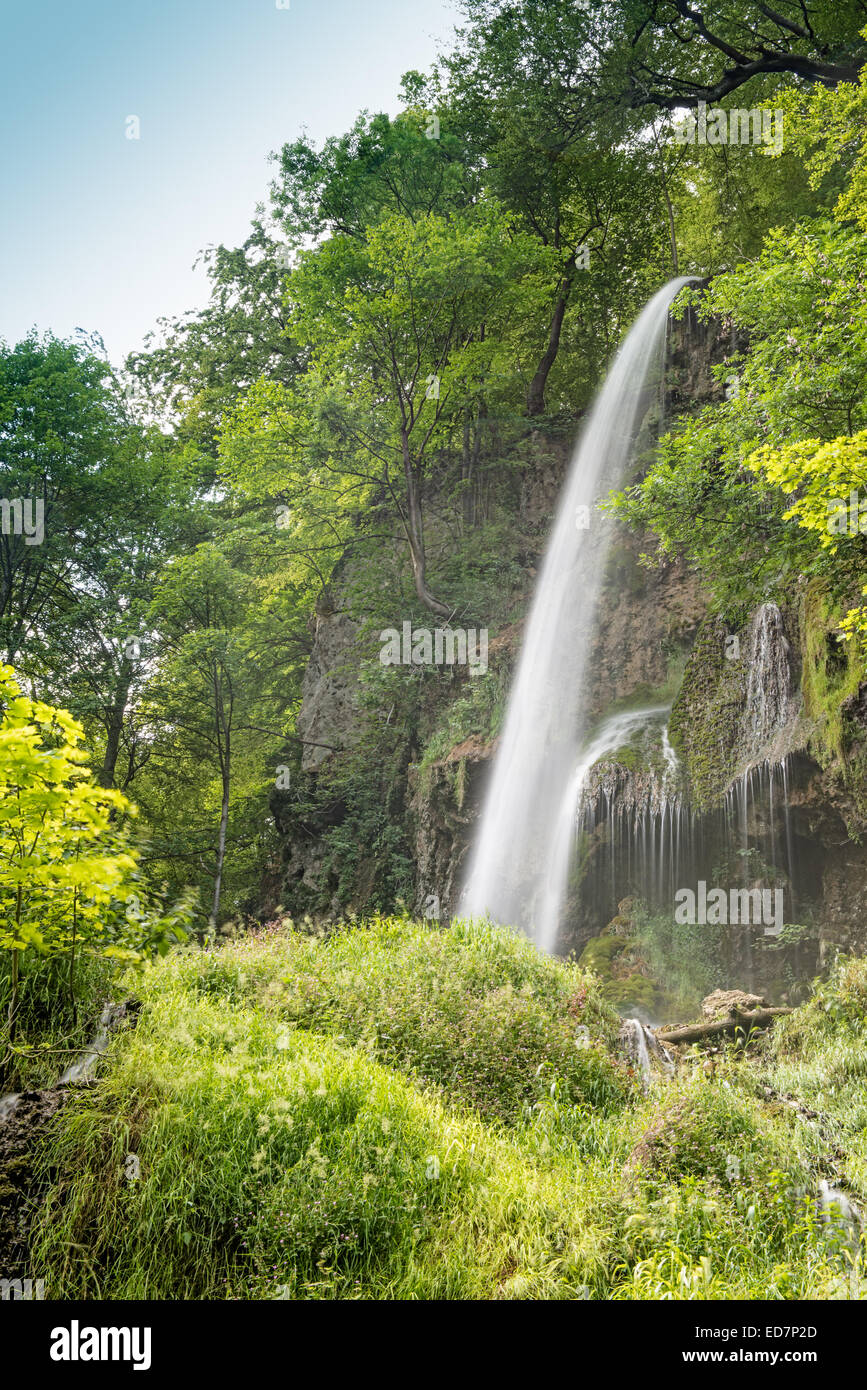 Waterfall is falling from a rock into the depth Stock Photo - Alamy