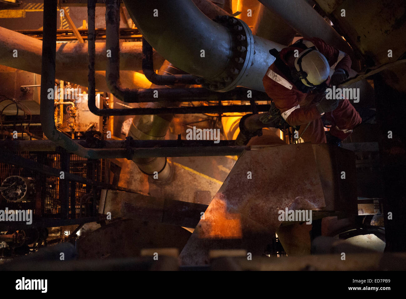 Rope access technician on a north sea oil gas rig installation. credit ...