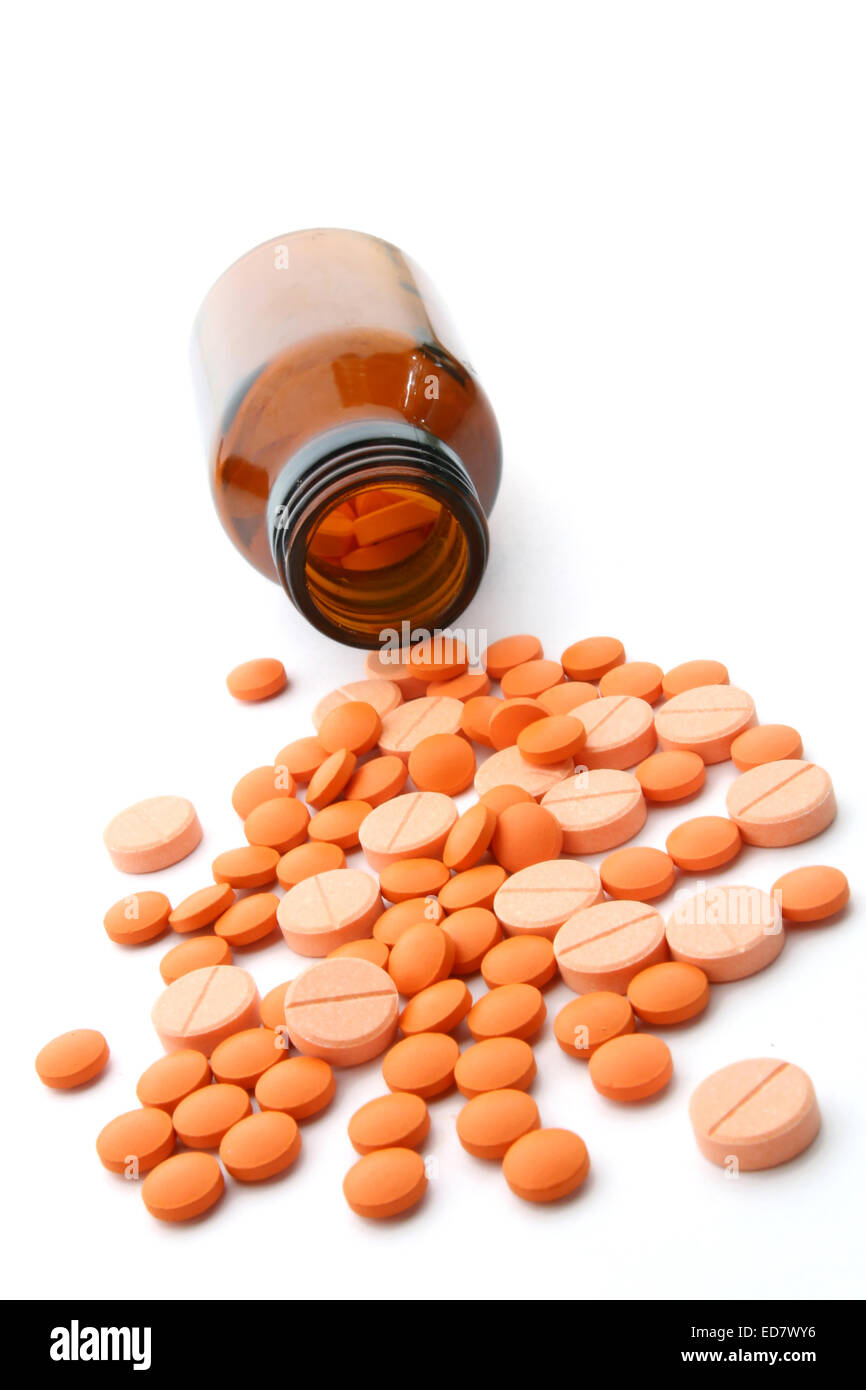 Open pill bottle with medicine spilling out of it isolated on white ...