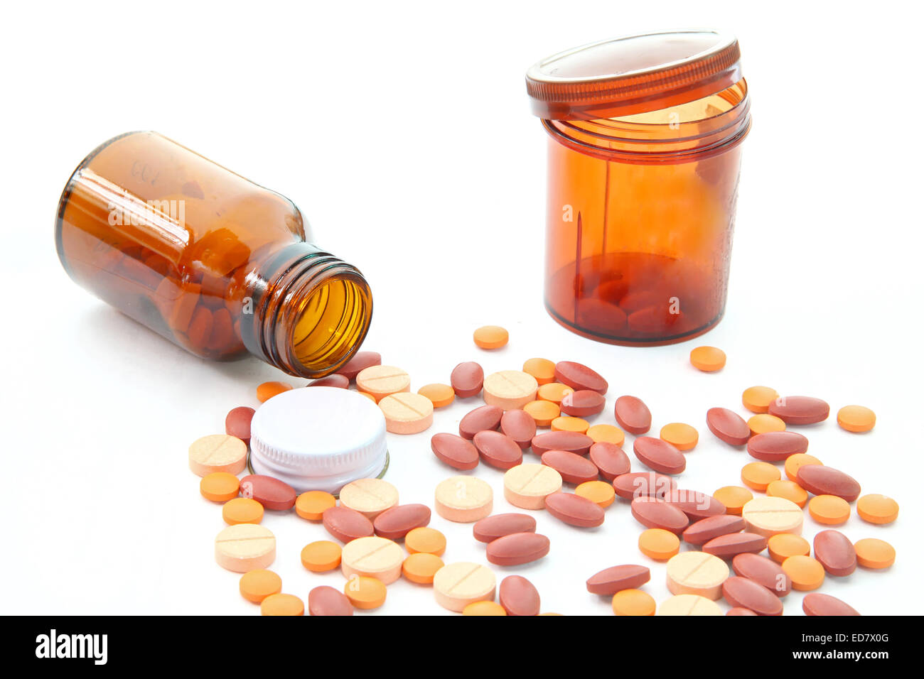 Perspective of pills spilling out from bottle Stock Photo - Alamy