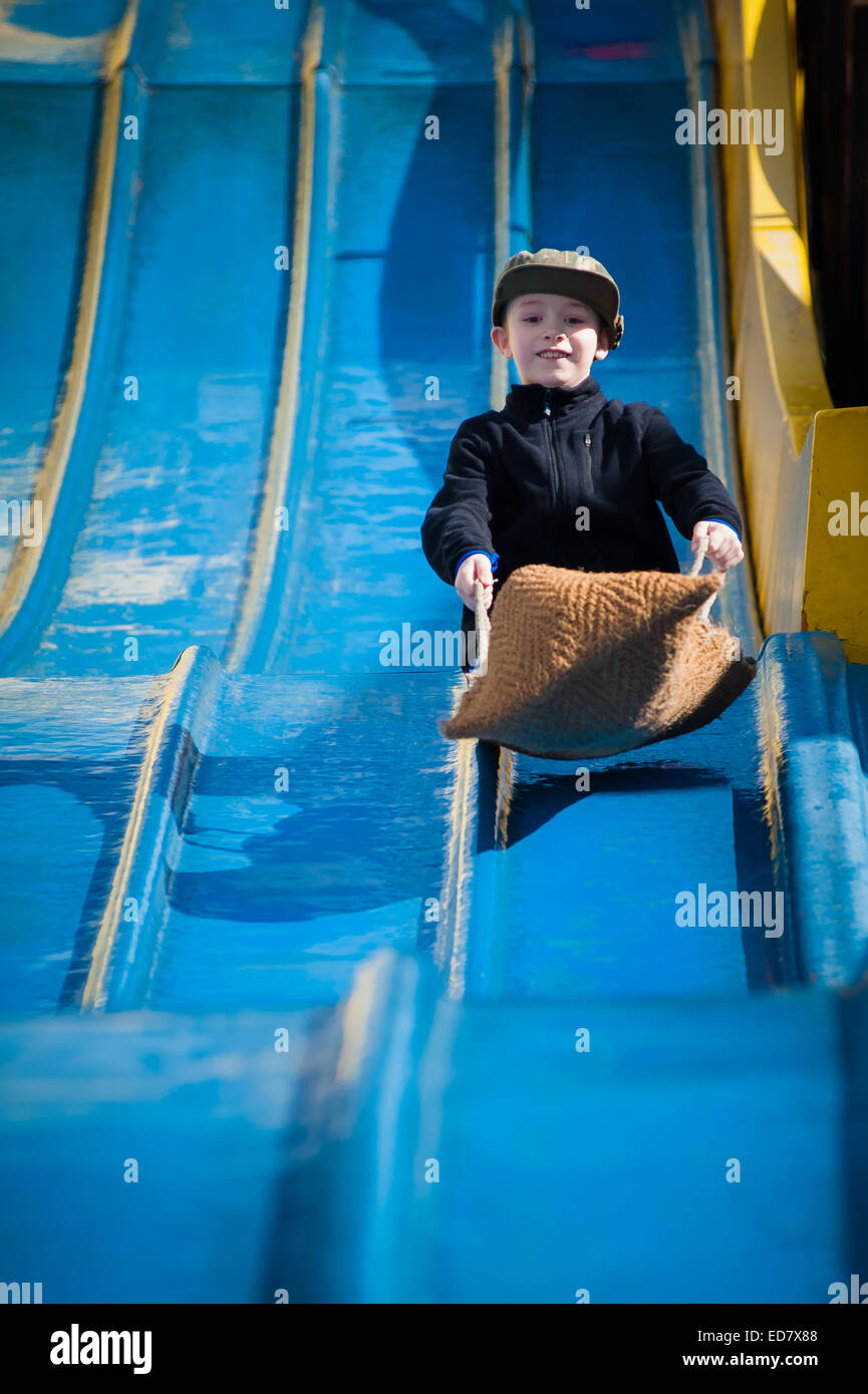 Happy boy going down slide hi-res stock photography and images - Alamy