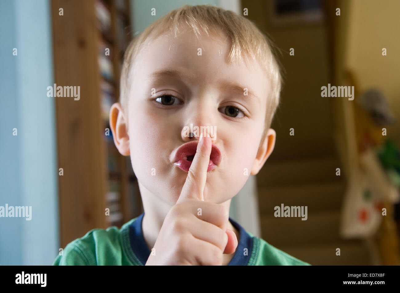 boy saying shhhh with finger against lips Stock Photo - Alamy