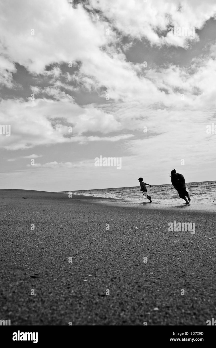 Man running on beach Black and White Stock Photos & Images - Alamy