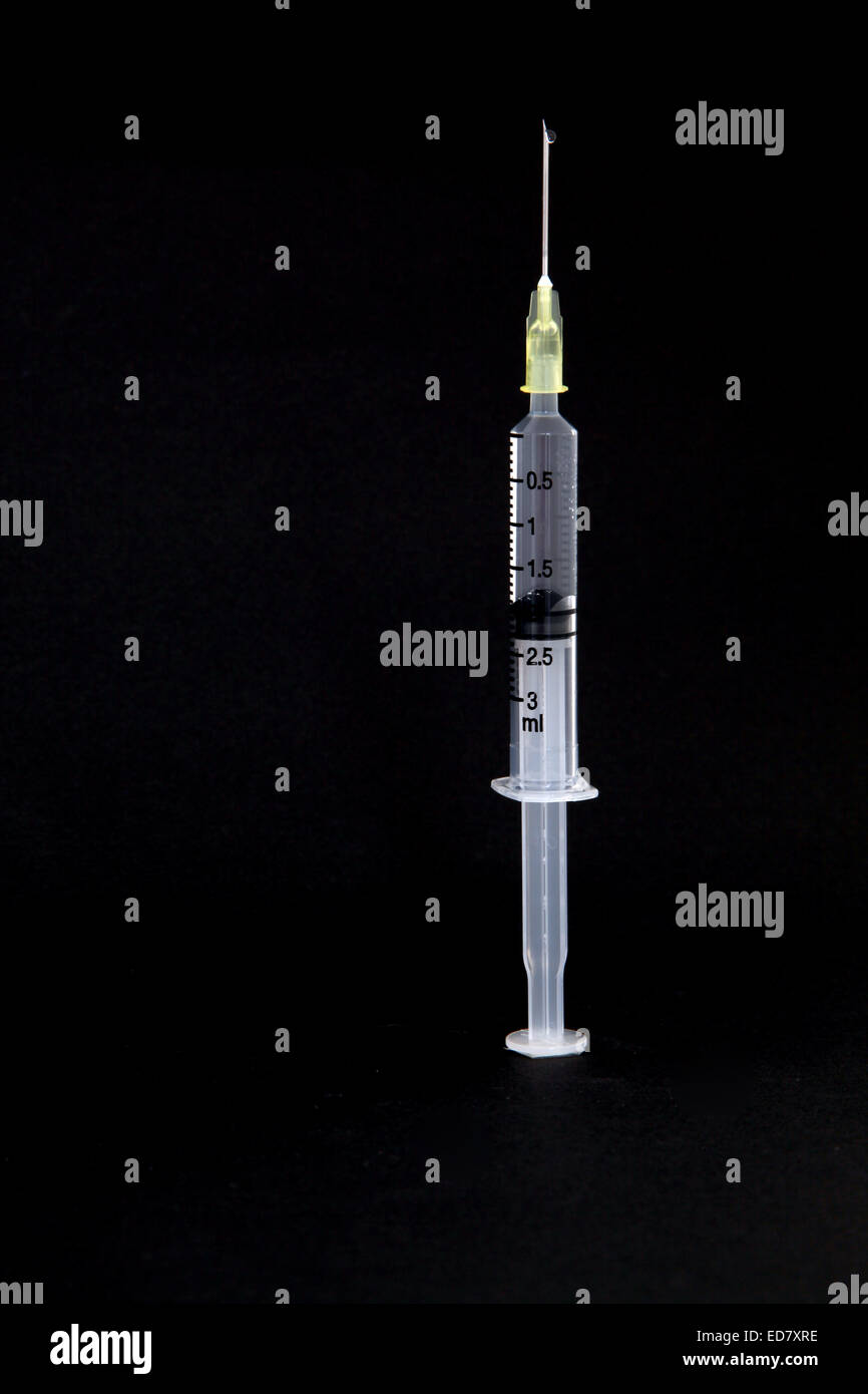 isolated syringe with needle and water drop on black background Stock ...