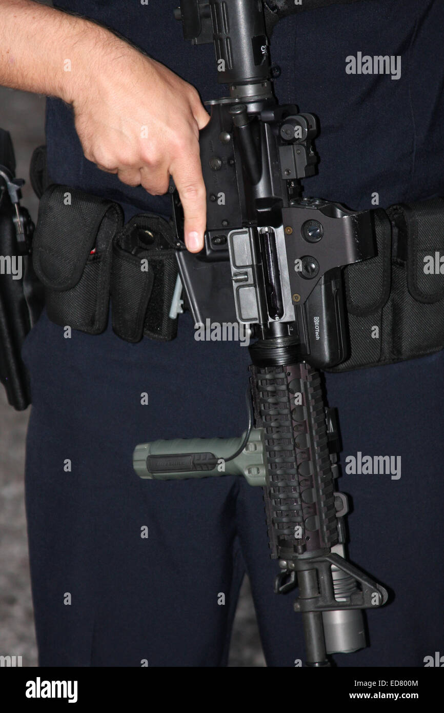 A Police Officer with a rifle Stock Photo - Alamy
