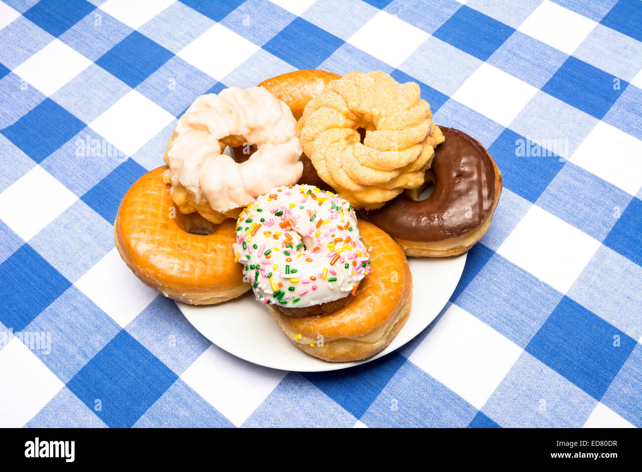 A plate of delicious, fresh donuts on a classic diner checkered blue ...