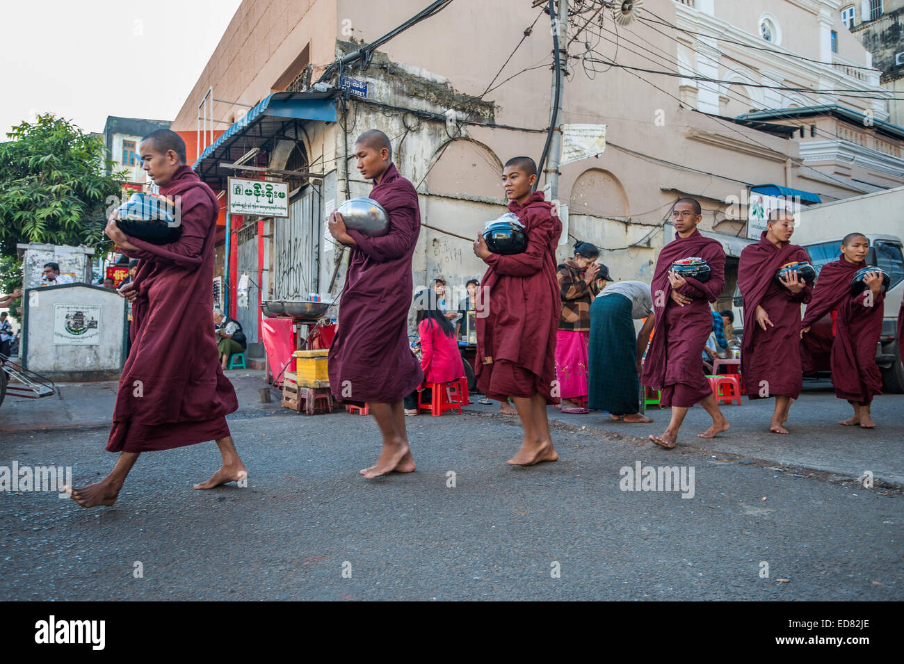 Procession of monks gathering alms in the early morning in Yangon Stock ...