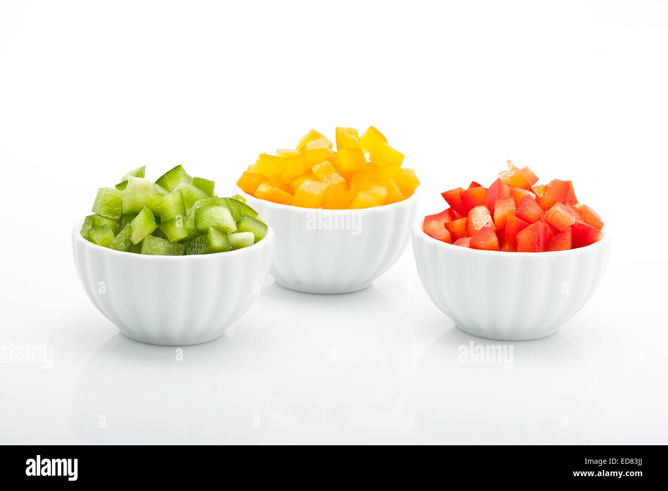 closeup of fresh chopped bits of red green yellow and orange pepper in ...