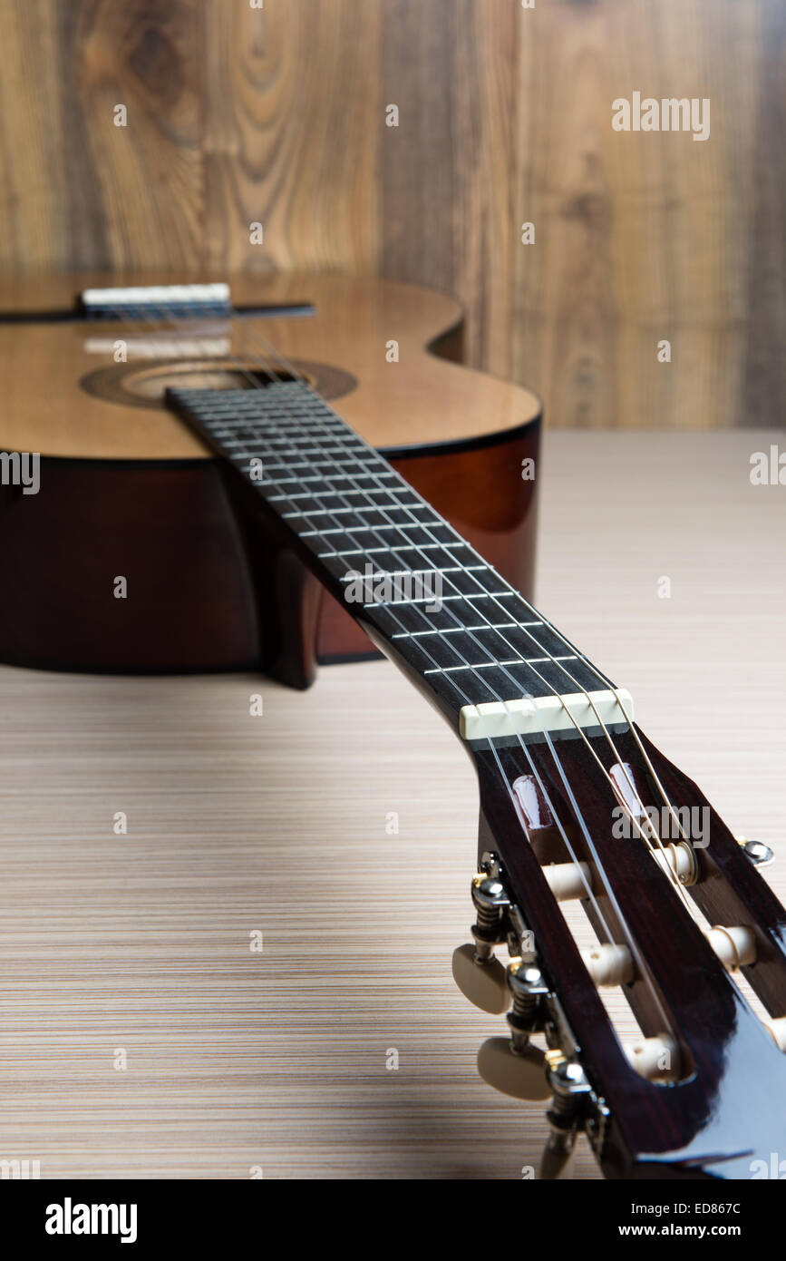 acoustic six-string guitar on the background of wooden panels Stock ...
