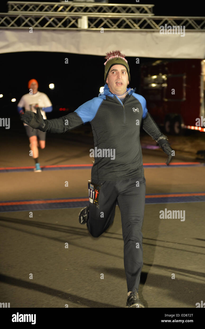 East Meadow, New York, USA. 1st Jan, 2015. A runner crosses the finish ...