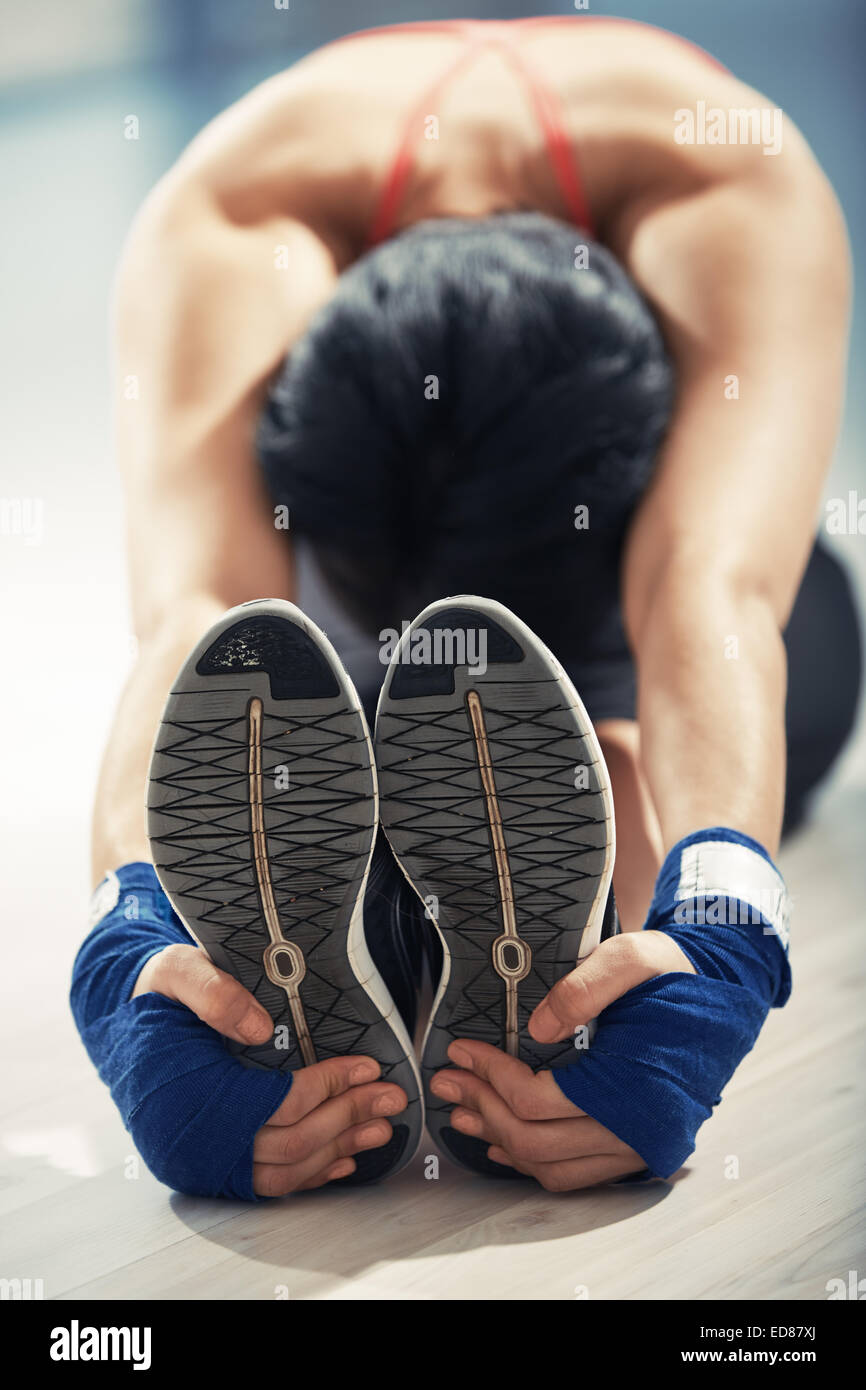 Stretching woman in exercising room Stock Photo - Alamy