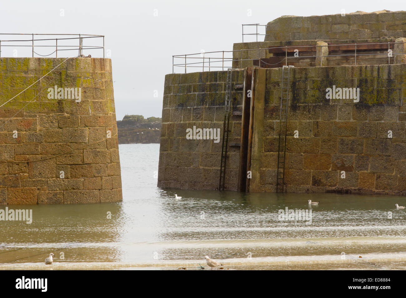 View through the opening in the Mousehole harbour wall, Cornwall ...