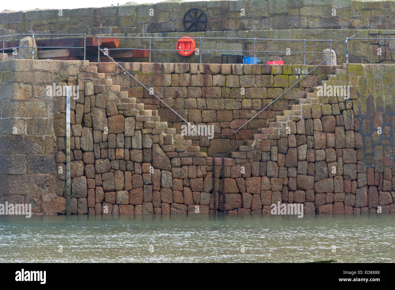 Stone carved steps at Mousehole harbour, Cornwall, England Stock Photo ...