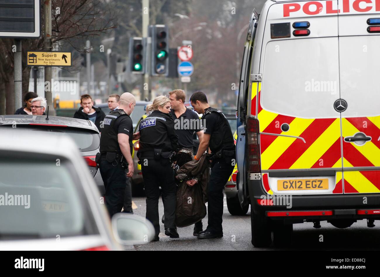 A woman is restrained and arrested by police for being drunk and ...