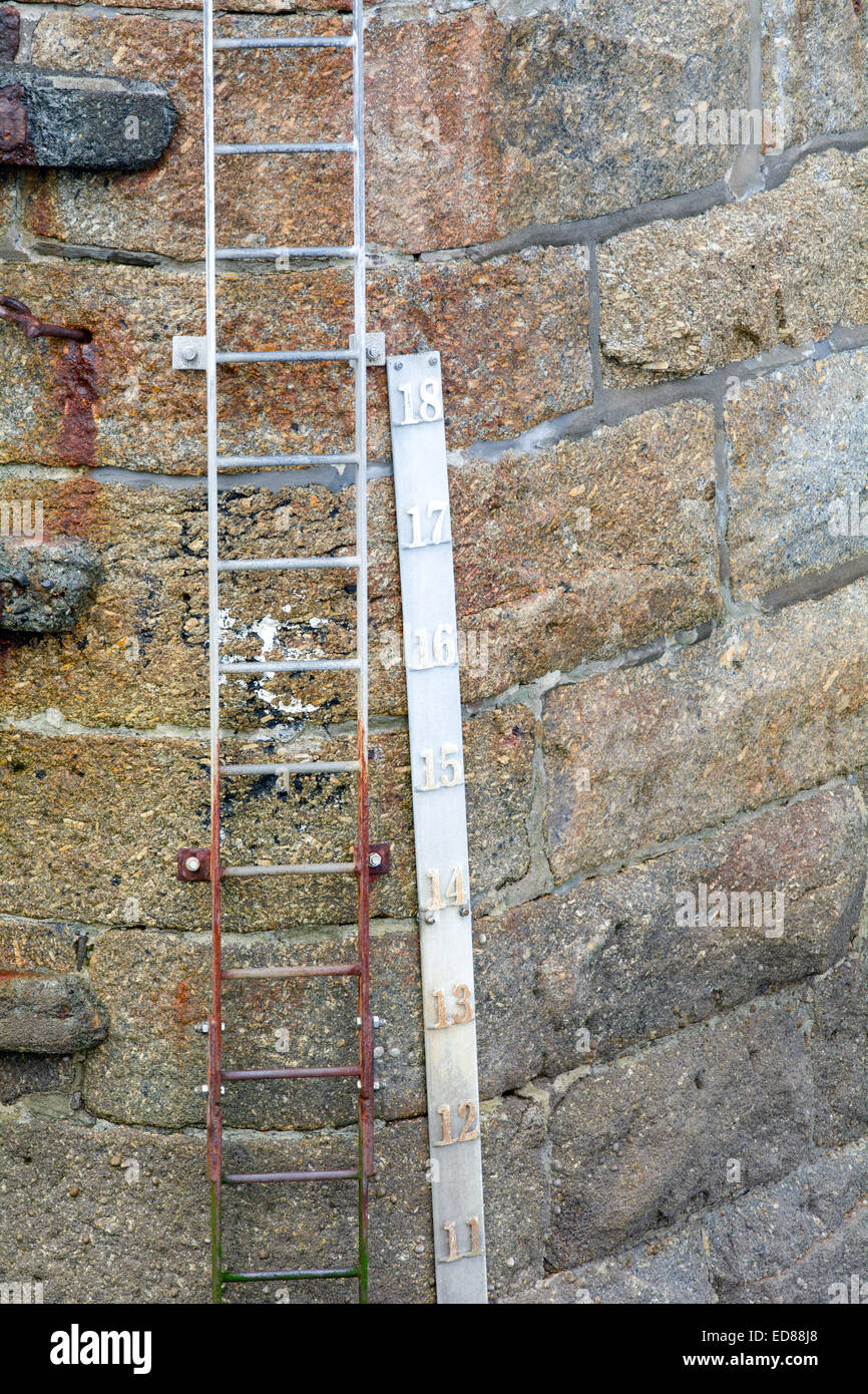 Depth marker on harbour wall in Mousehole, Cornwall, England Stock ...