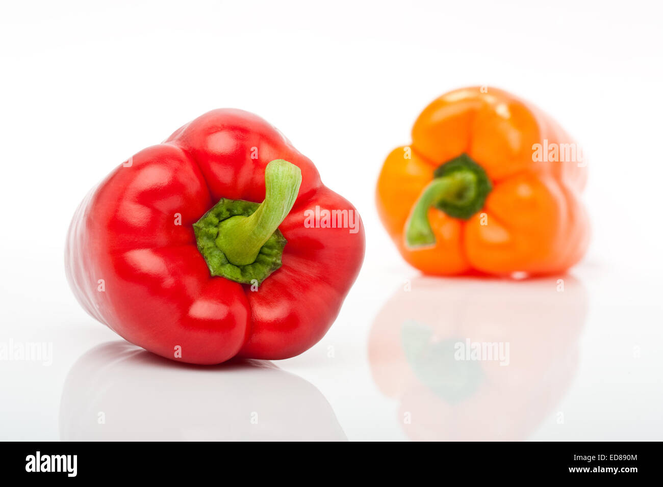 a pair of orange and red pepper isolated on white background Stock ...