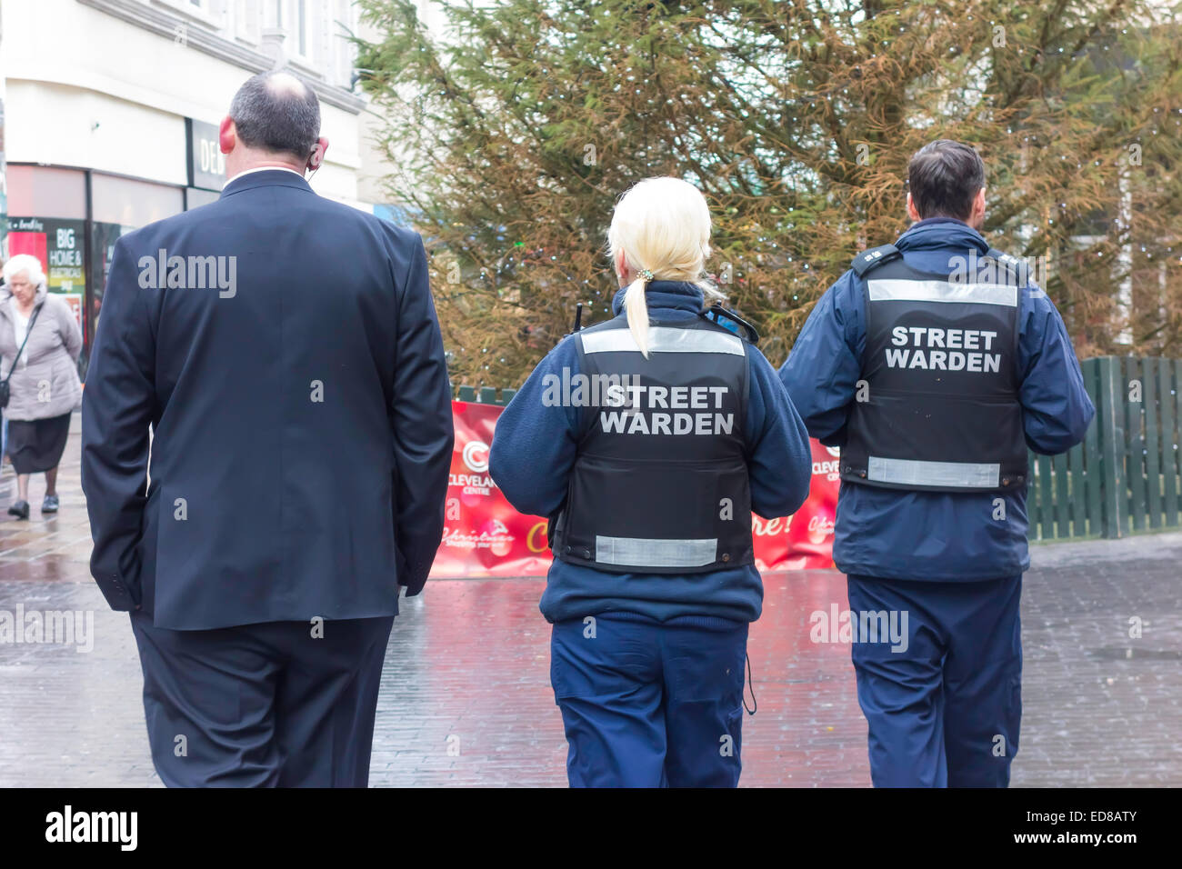 Town centre security man with male and female Street Wardens on street ...