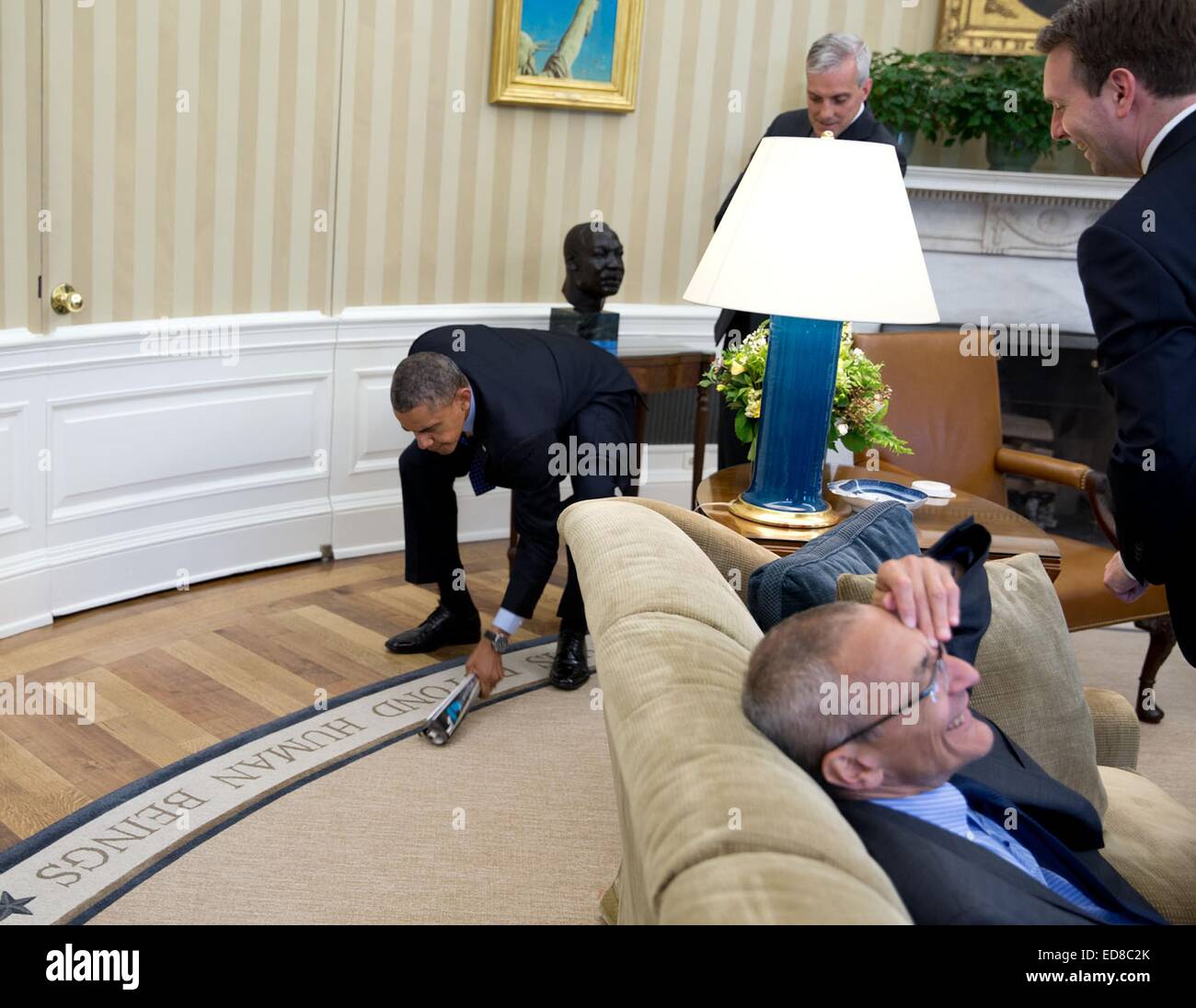 US President Barack Obama uses a rolled magazine to swat a fly during a ...