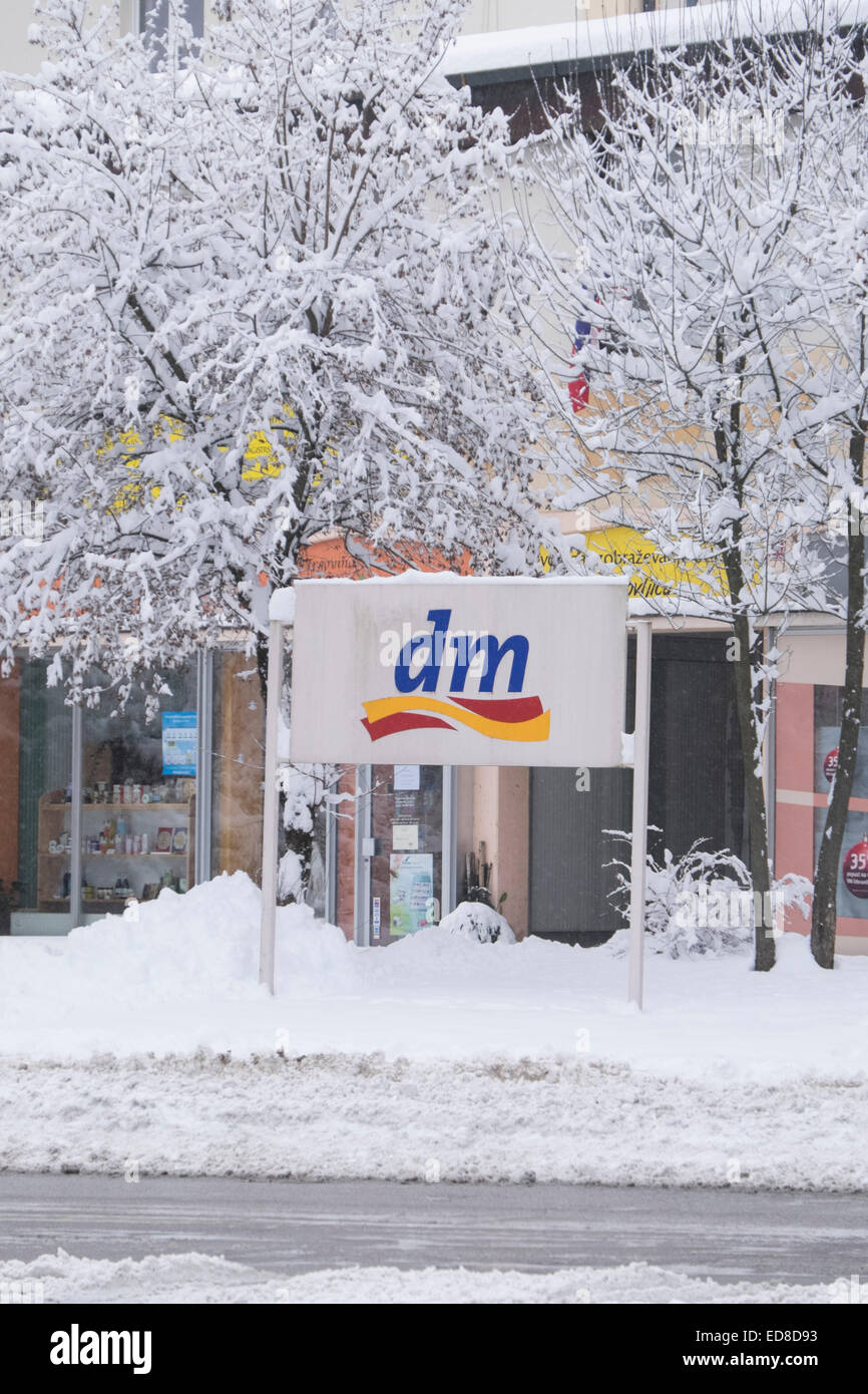 DM supermarket sign covered with snow in in Radovljica, Slovenia Stock ...