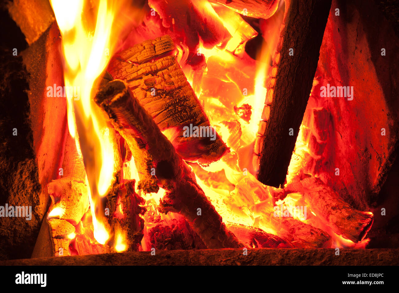 Warmly glow of a traditional winter scene as the open fire in a home ...