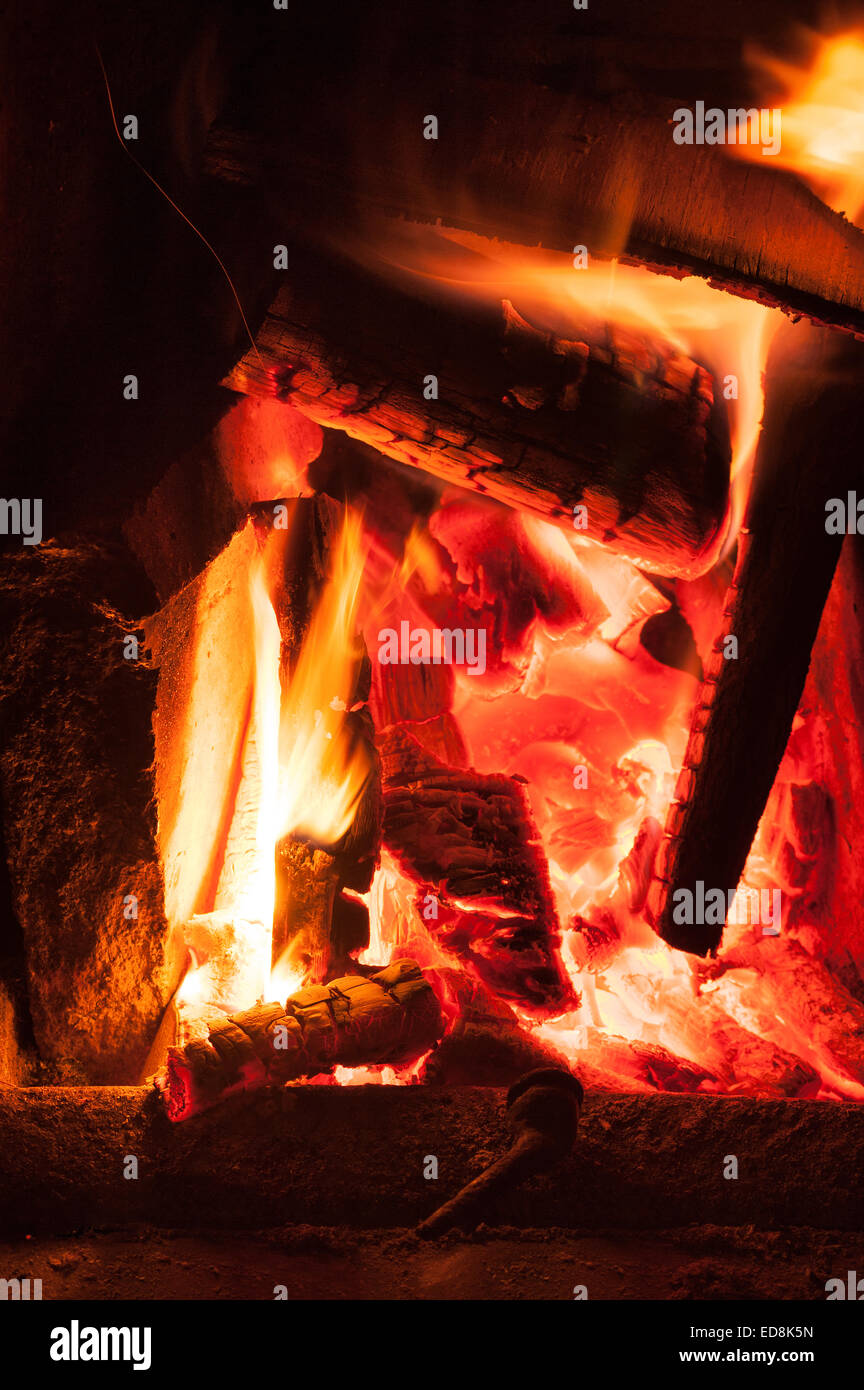 Warmly glow of a traditional winter scene as the open fire in a home ...