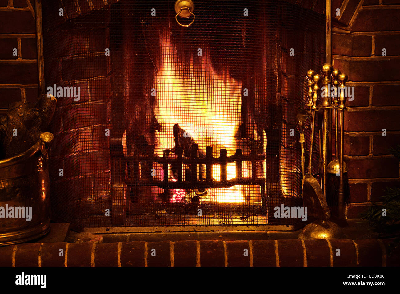 Warmly glow of a traditional winter scene as the open fire in a home ...