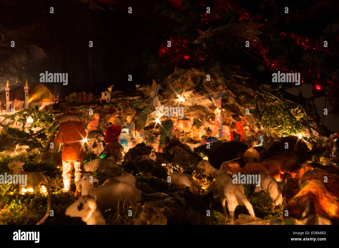 Nativity under the Christmas tree lit and decorated Stock Photo - Alamy