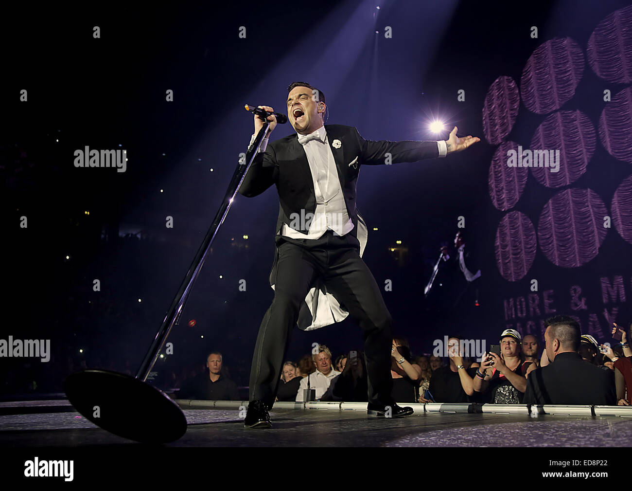 Robbie Williams performing live on stage at the Manchester Phones4U ...