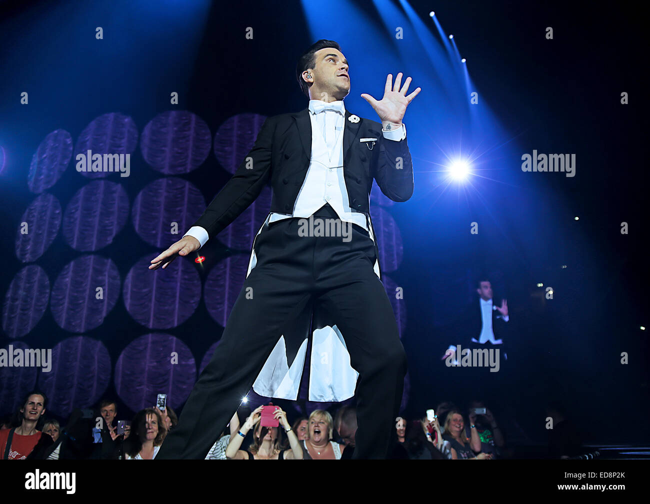 Robbie Williams performing live on stage at the Manchester Phones4U ...