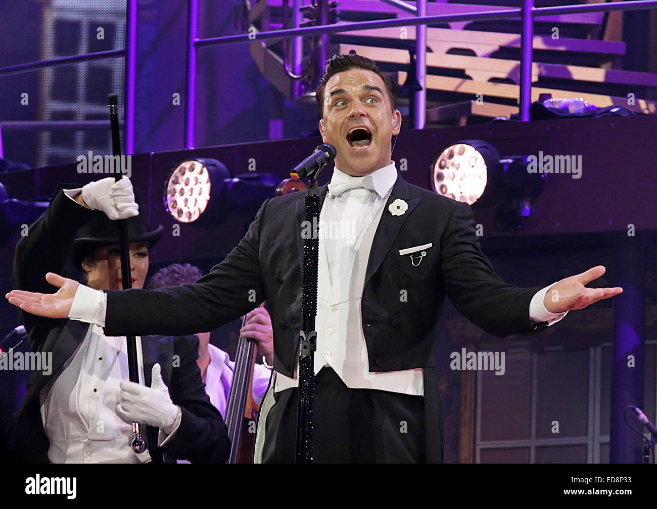 Robbie Williams performing live on stage at the Manchester Phones4U ...