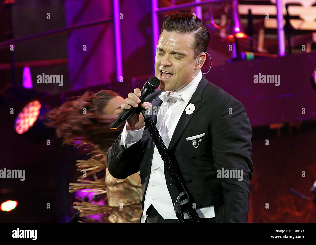 Robbie Williams performing live on stage at the Manchester Phones4U ...
