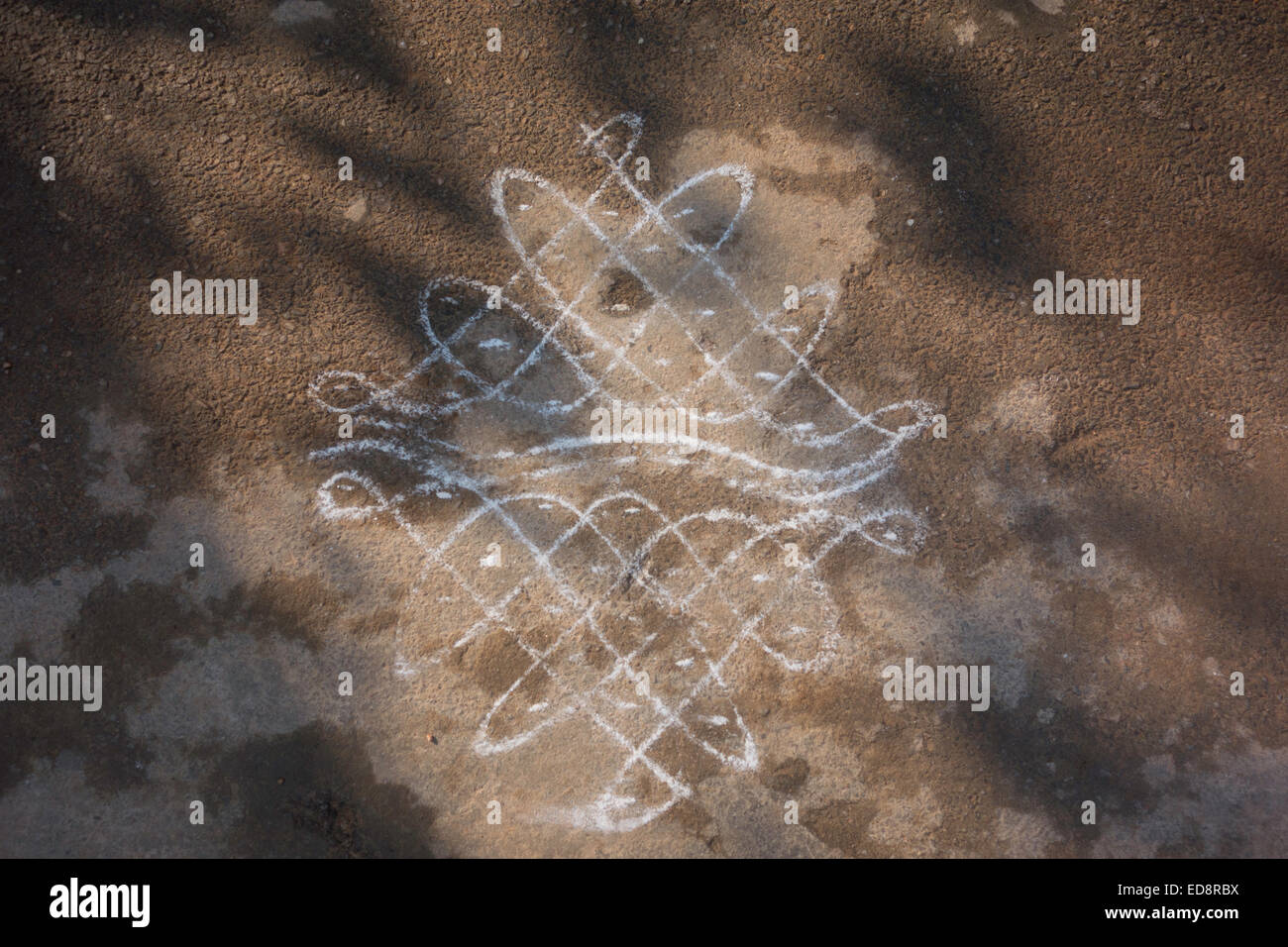 A chalk pattern on the pavement outside someone's house in Mysore as a ...