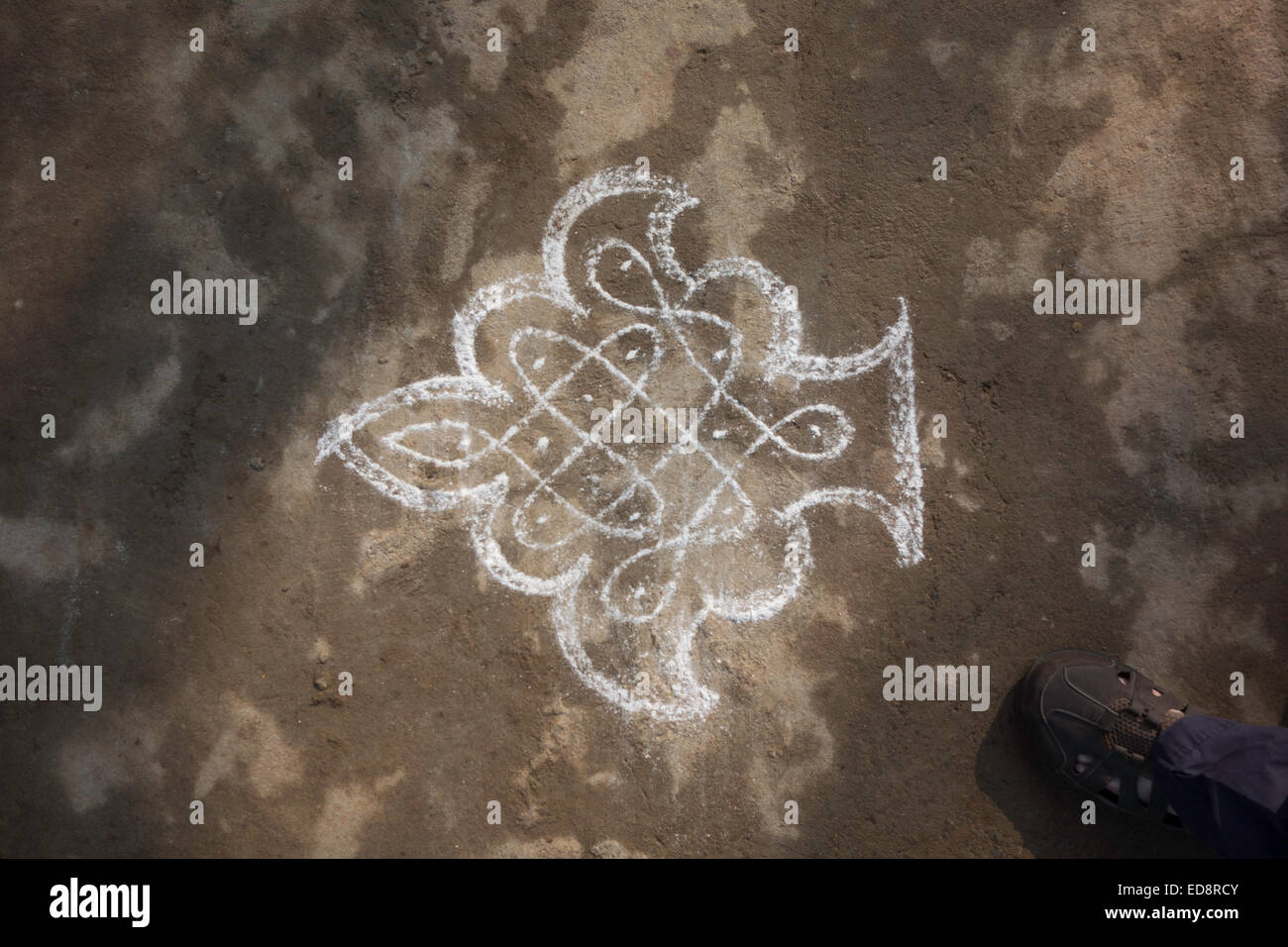A chalk pattern on the pavement outside someone's house in Mysore as a ...