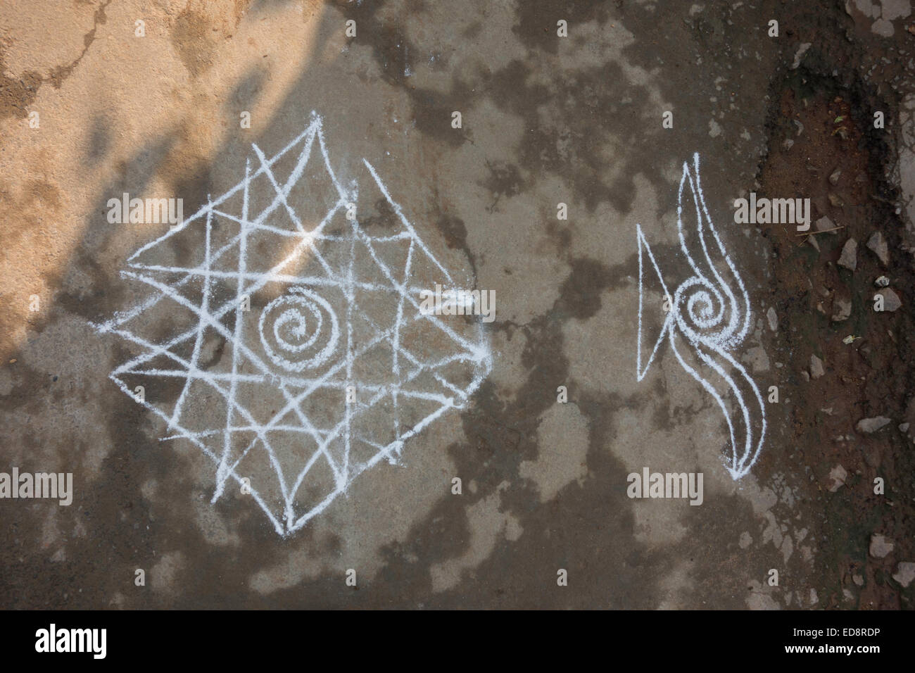 A chalk pattern on the pavement outside someone's house in Mysore as a ...