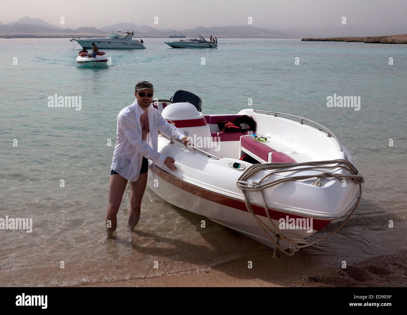 Captain and boat Stock Photo - Alamy