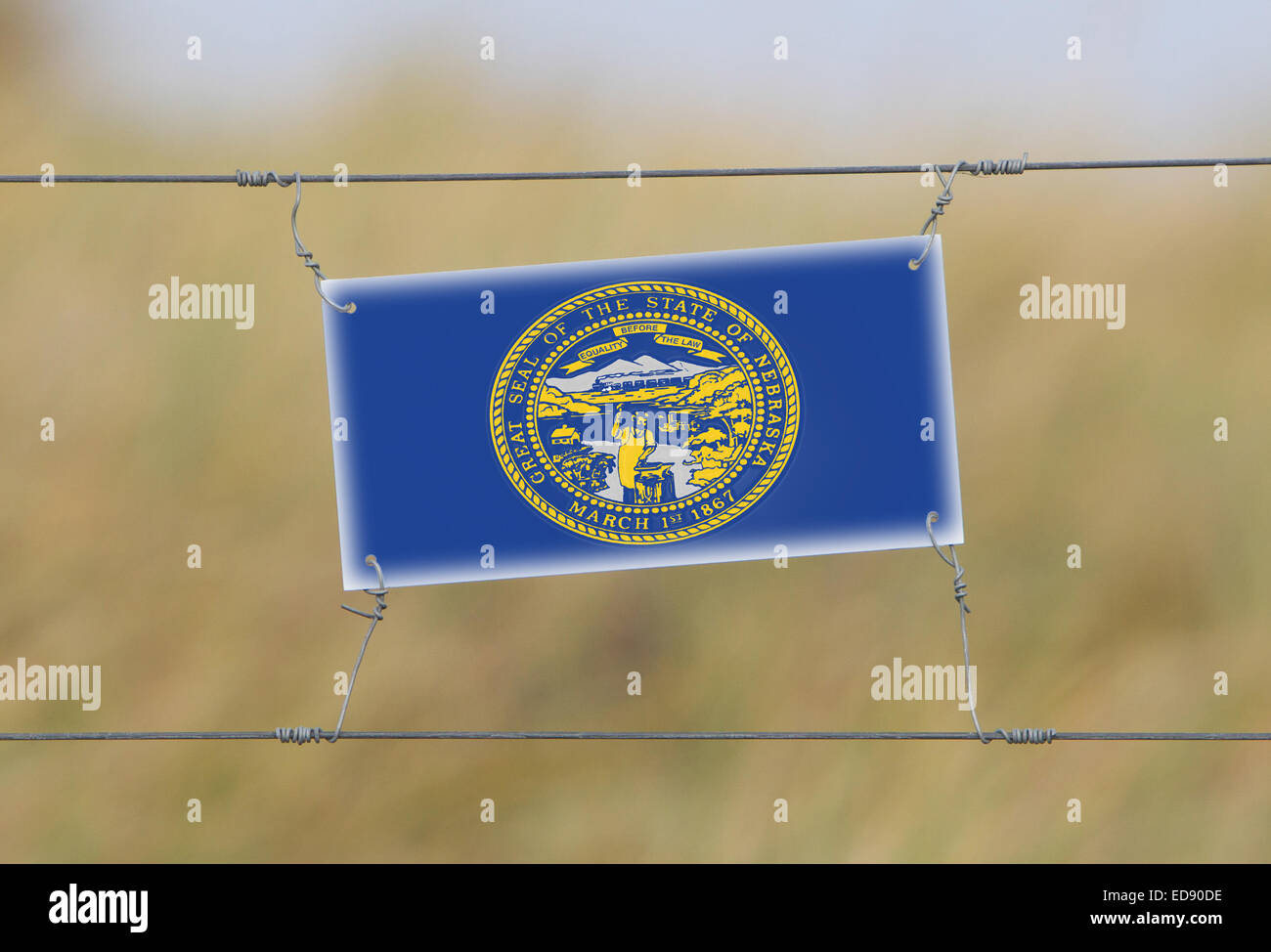 Border fence - Old plastic sign with a flag - Nebraska Stock Photo - Alamy