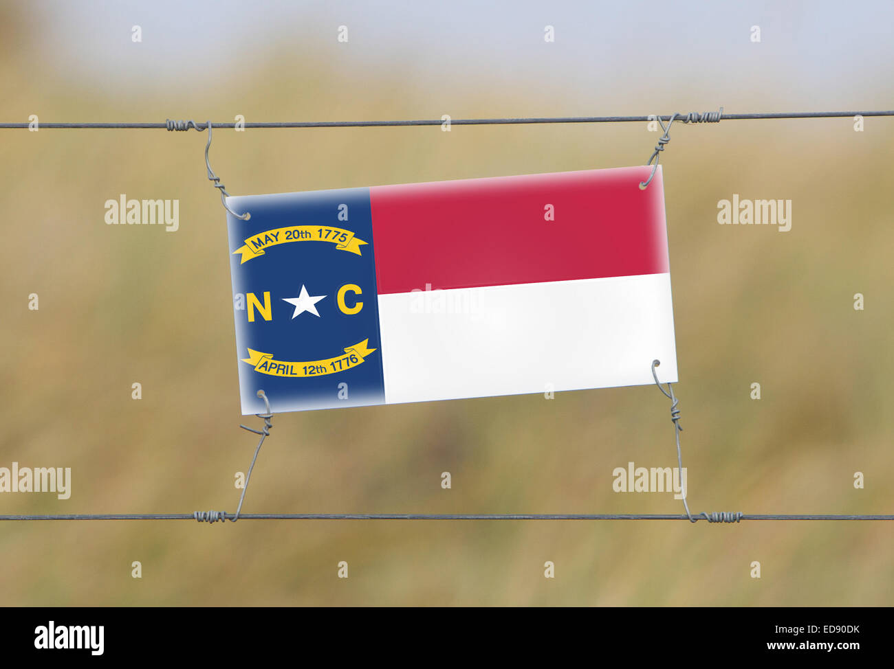 Border fence - Old plastic sign with a flag - North Carolina Stock ...
